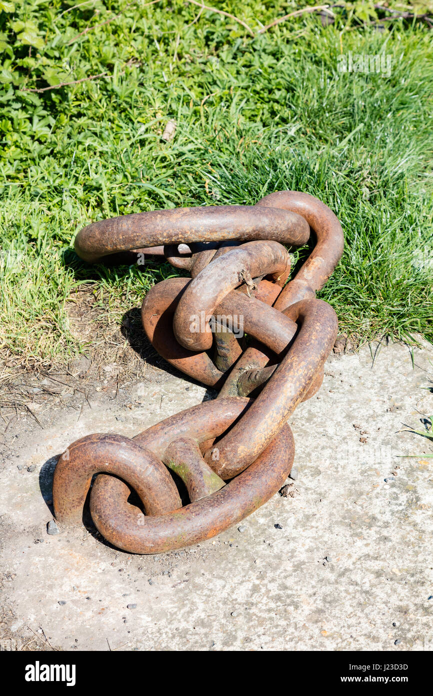 Large mooring chains, shackles and rings on the footpath beside the ...