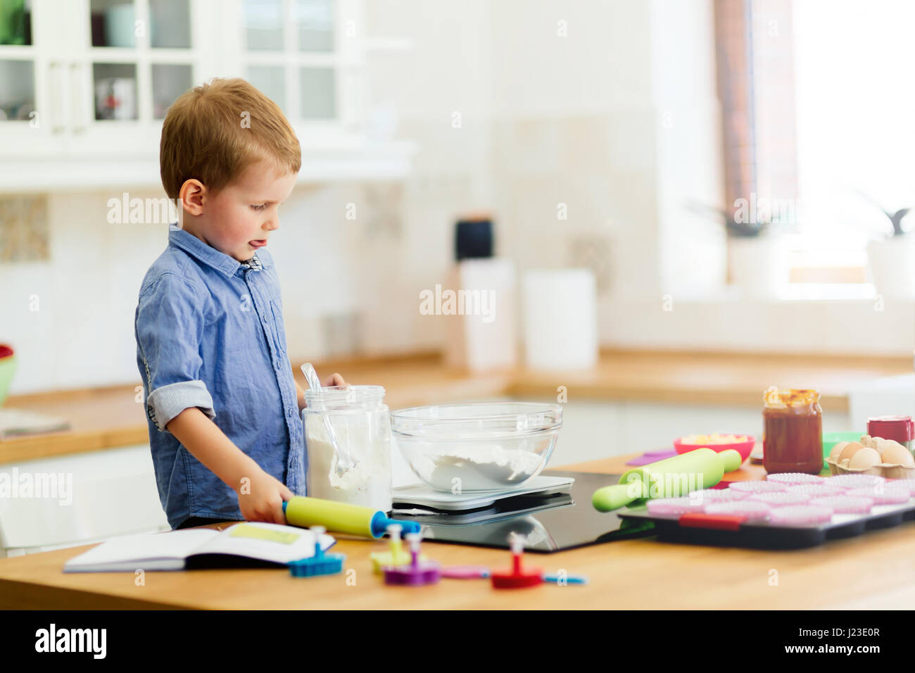 Adorable child below the age of 3 making cookies in kitchen Stock Photo ...