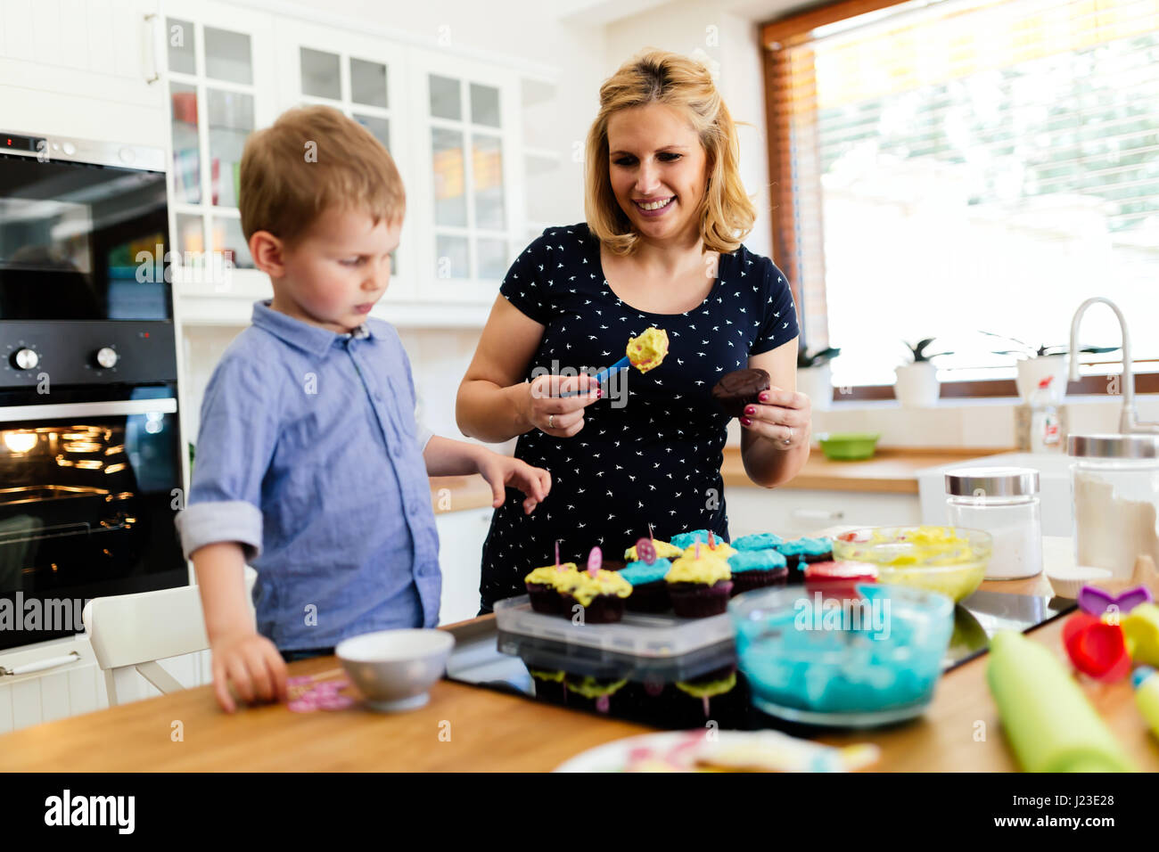 Beautiful child and mother baking in kitchen with love Stock Photo - Alamy