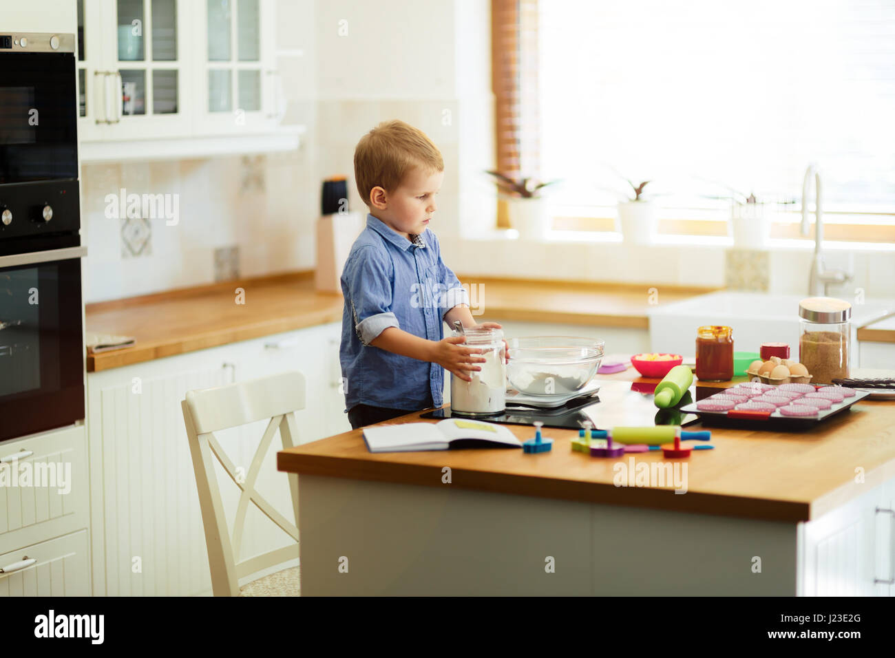 Adorable child below the age of 3 making cookies in kitchen Stock Photo ...