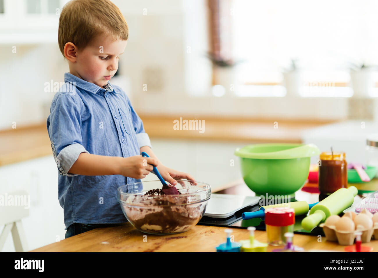 Adorable child below the age of 3 making cookies in kitchen Stock Photo ...