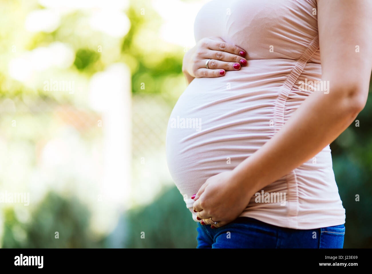 Pregnant young woman in green hi-res stock photography and images - Alamy