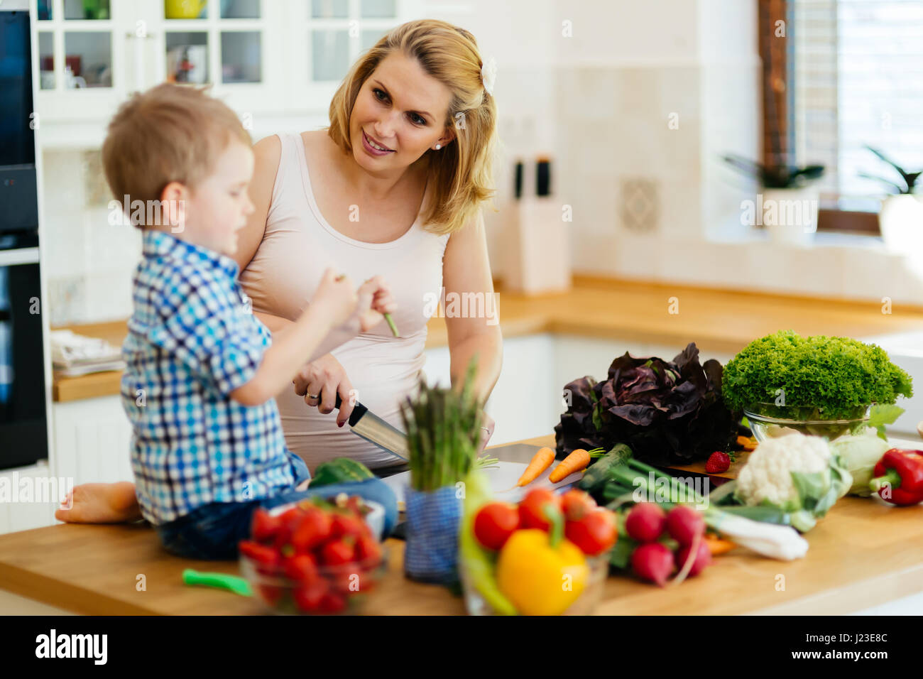 Mother and child preparing lunch in kitchen Stock Photo - Alamy