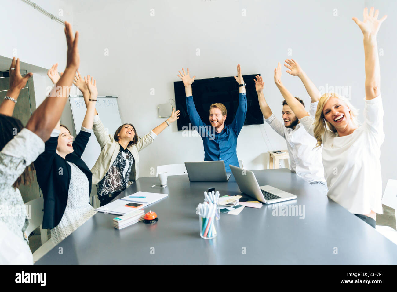 Happy colleagues are cheering after successfully completing task Stock ...