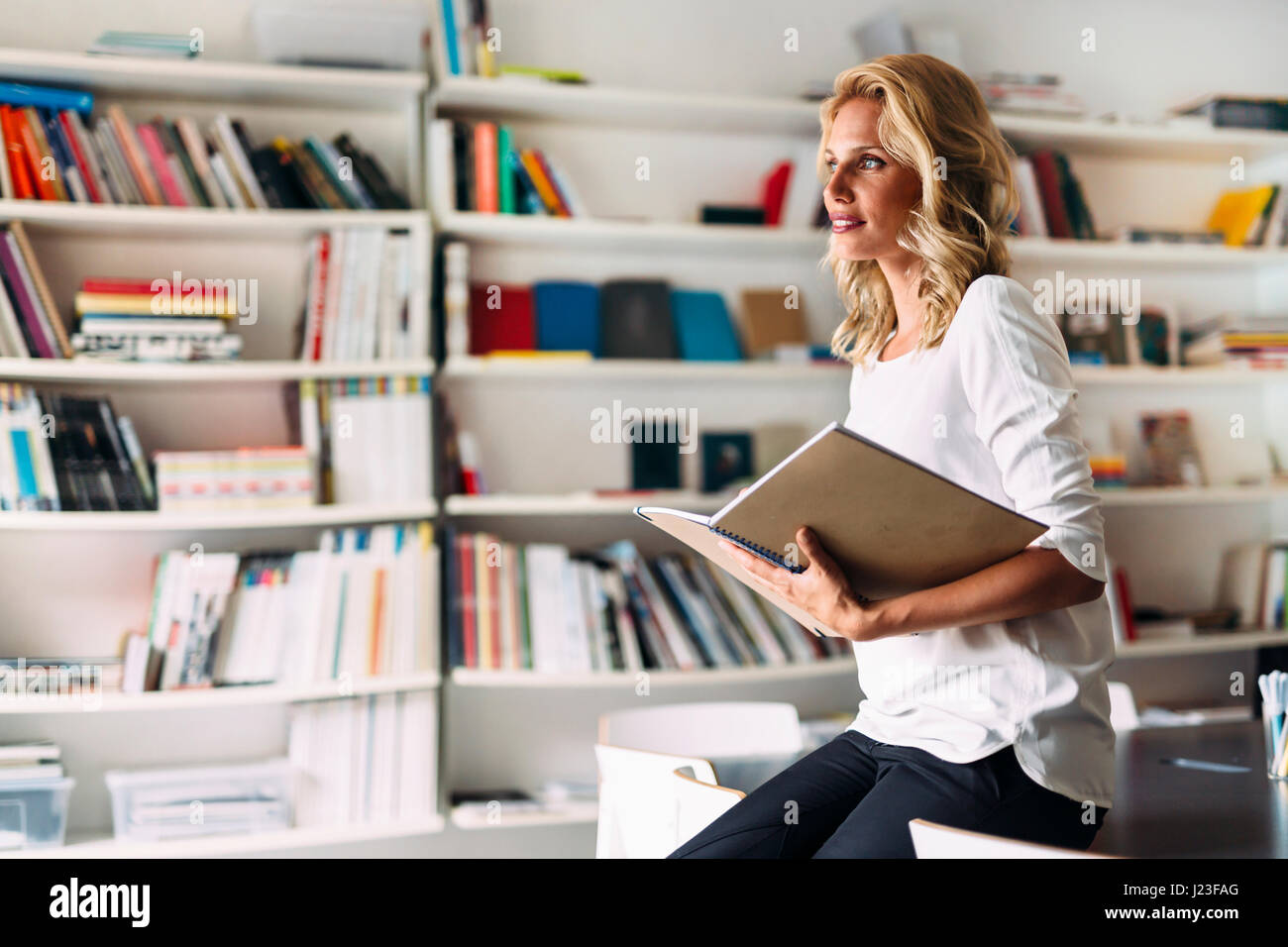 Stunning woman reading a book Stock Photo - Alamy
