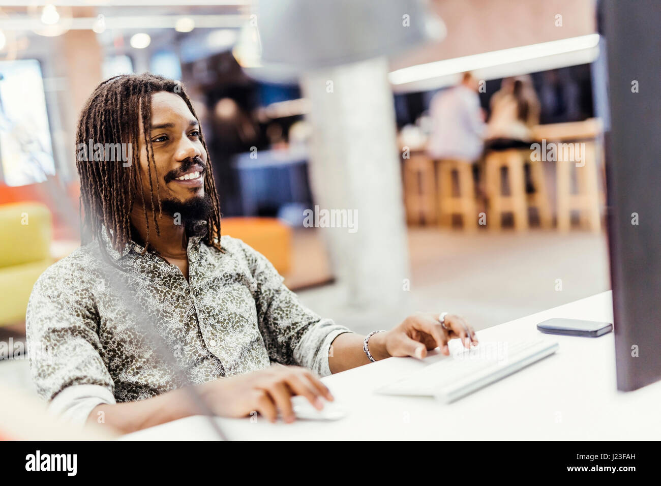 Black man in office desk hi-res stock photography and images - Alamy