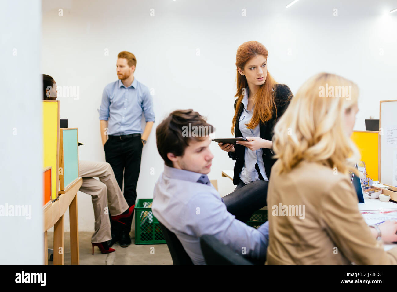 Coworkers solving problems together in modern office Stock Photo - Alamy