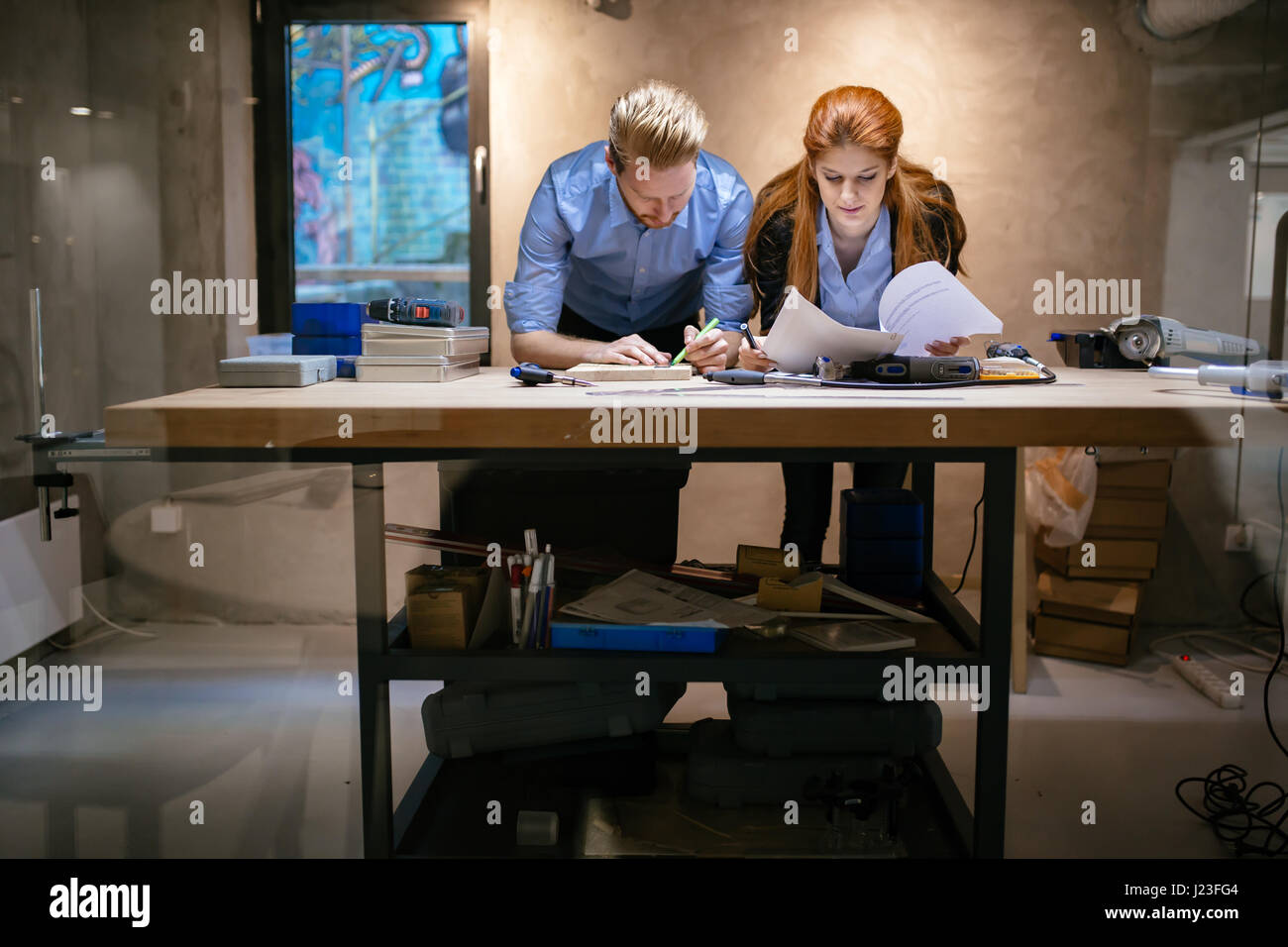 People working in modern beautiful workshop with professional equipment ...