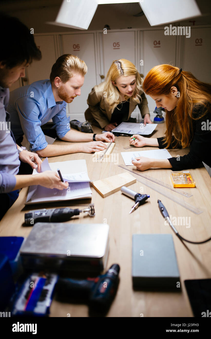 Classmates working on a project together and cooperating Stock Photo ...
