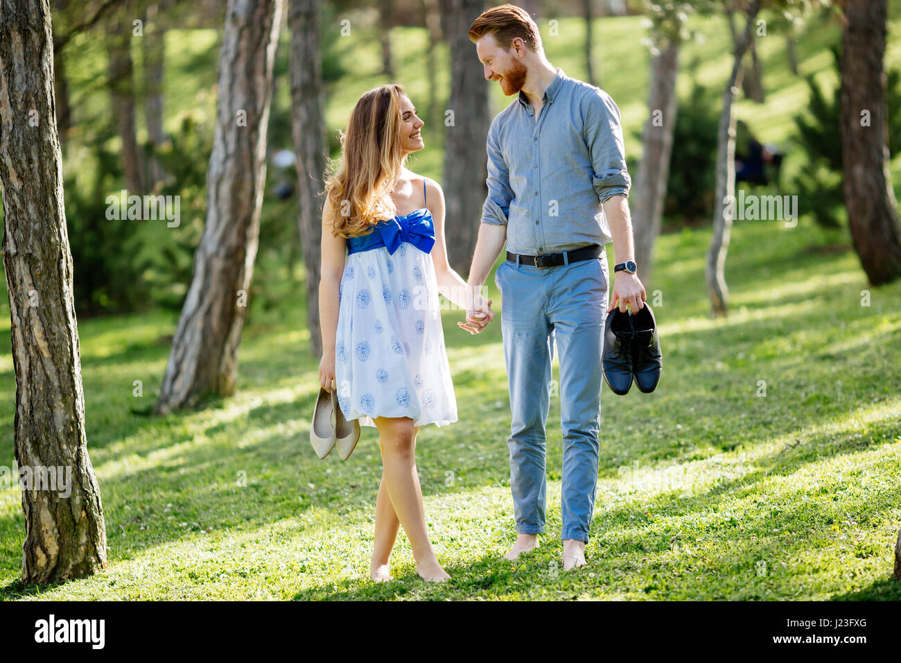 Romantic couple walking forest barefoot Stock Photo - Alamy