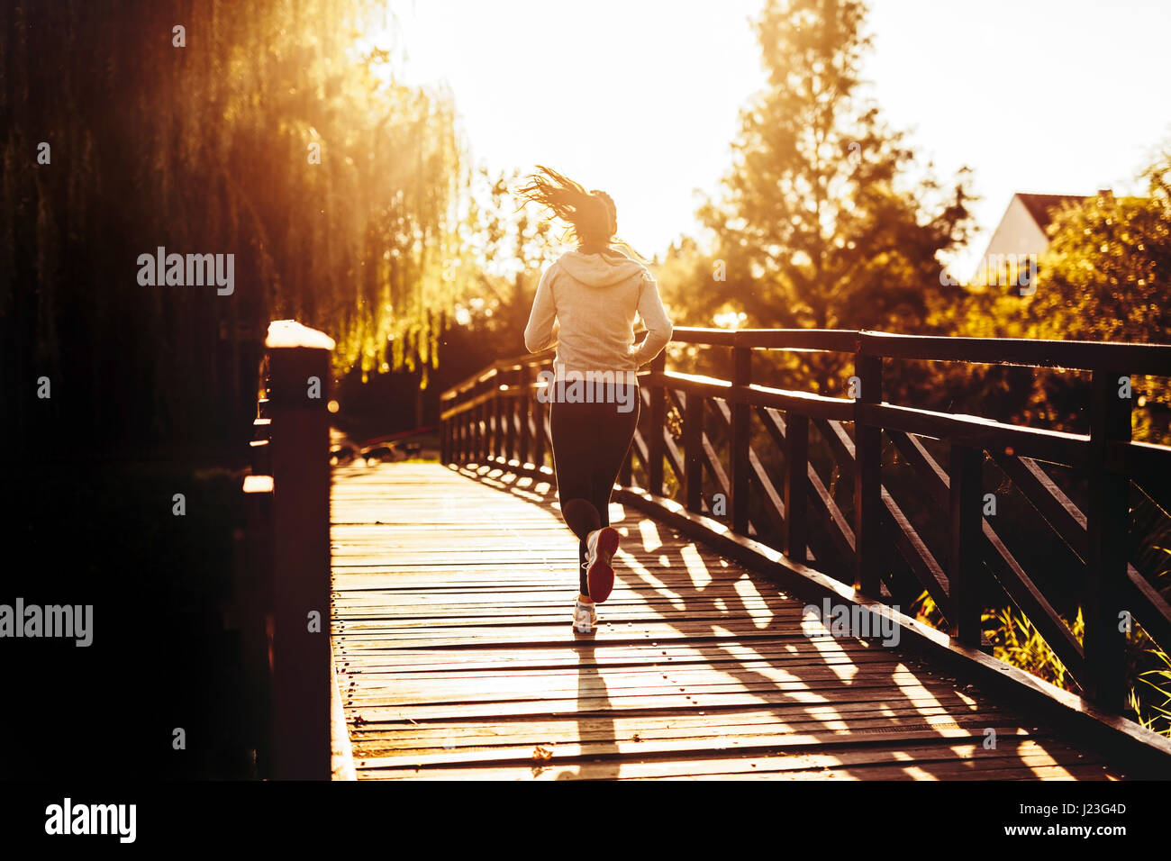 Beautiful female runner jogging in nature Stock Photo - Alamy