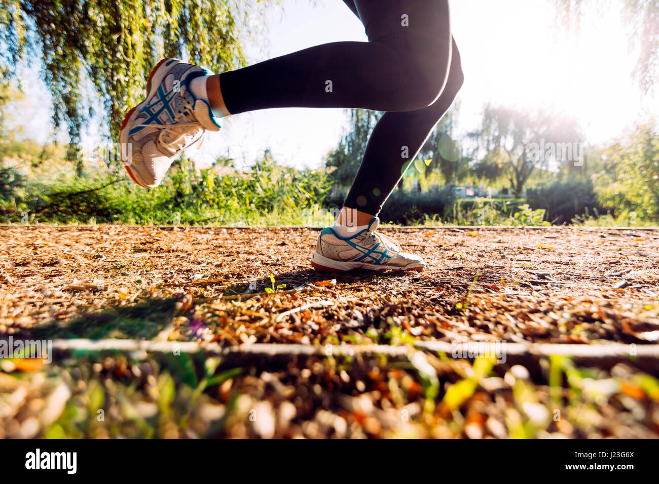 Jogging athlete in motion while running in nature outdoors Stock Photo ...