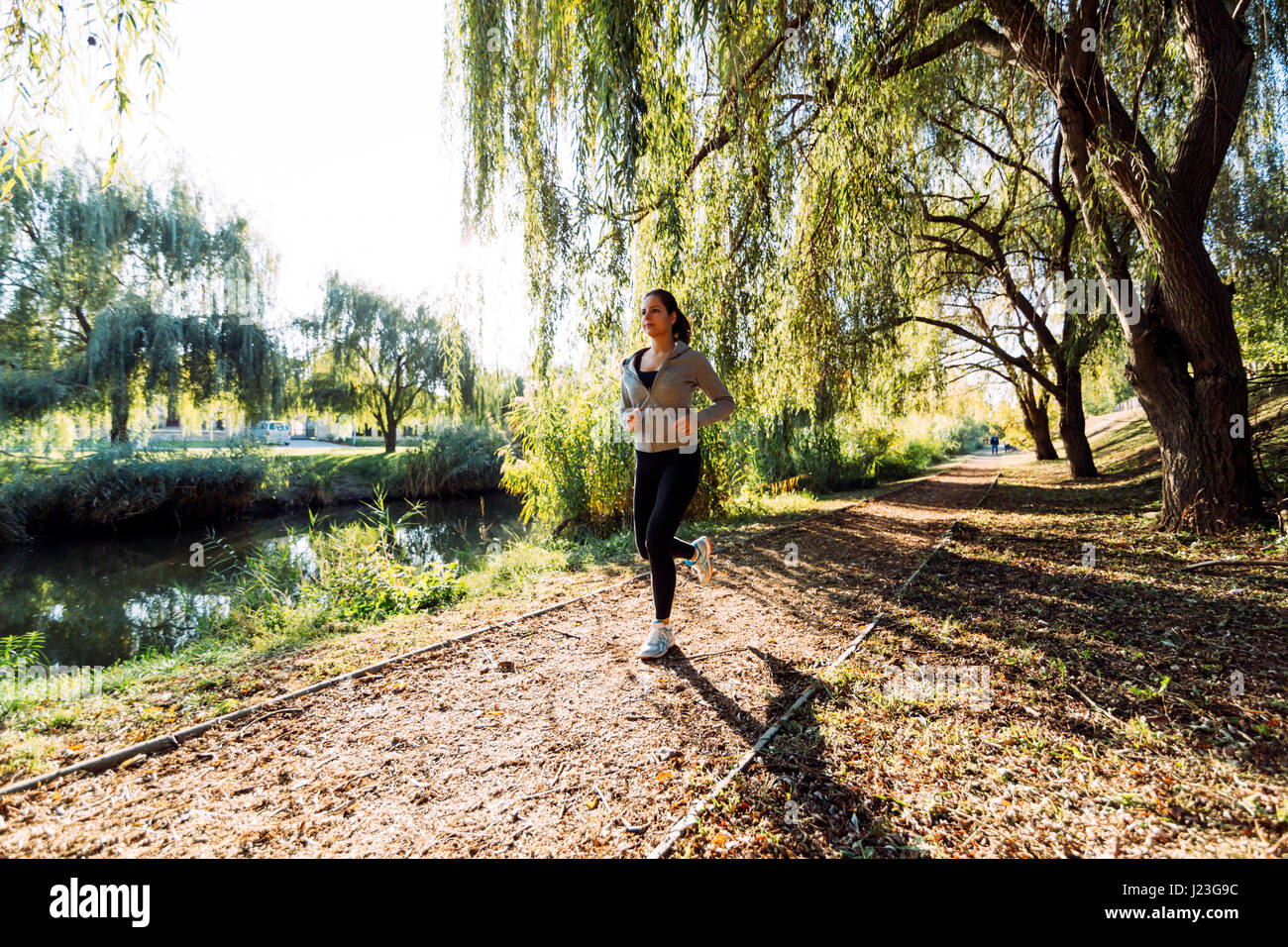 Fit woman jogging outdoors in nature Stock Photo - Alamy