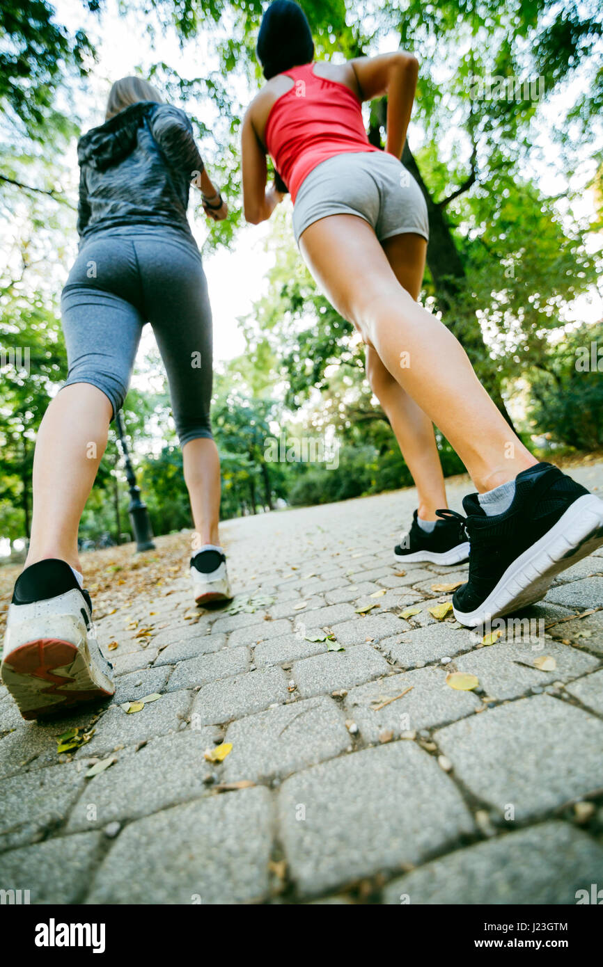 Sporty women jogging outdoors in park Stock Photo - Alamy