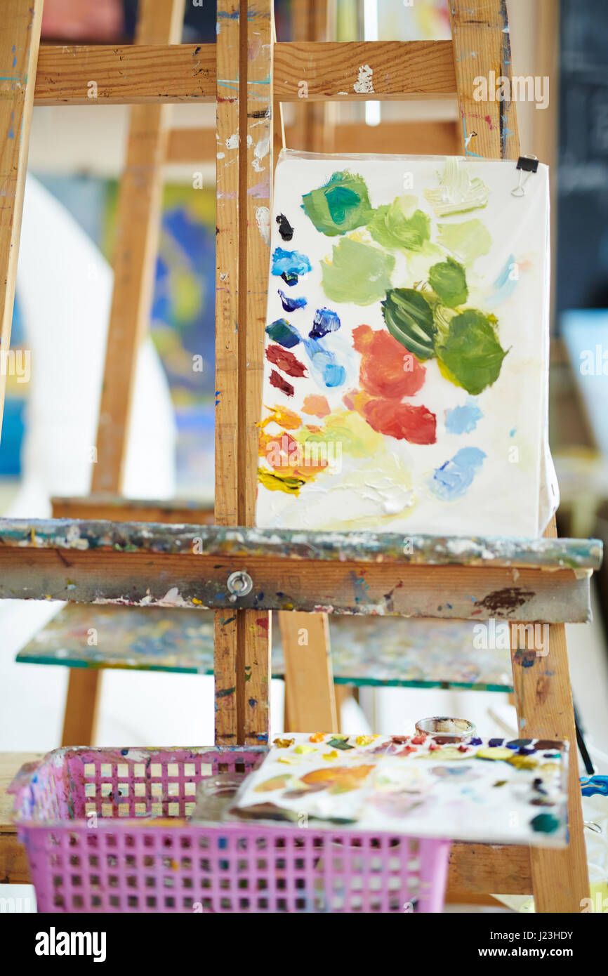Sheet of paper with various paint colors on easel Stock Photo - Alamy