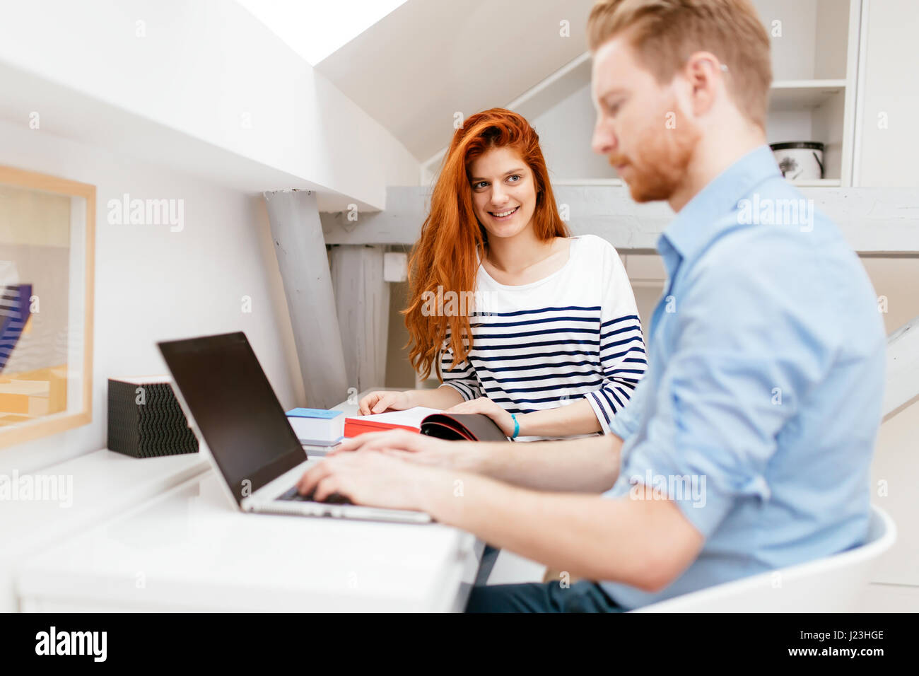 Husband and wife working from home on laptop Stock Photo - Alamy