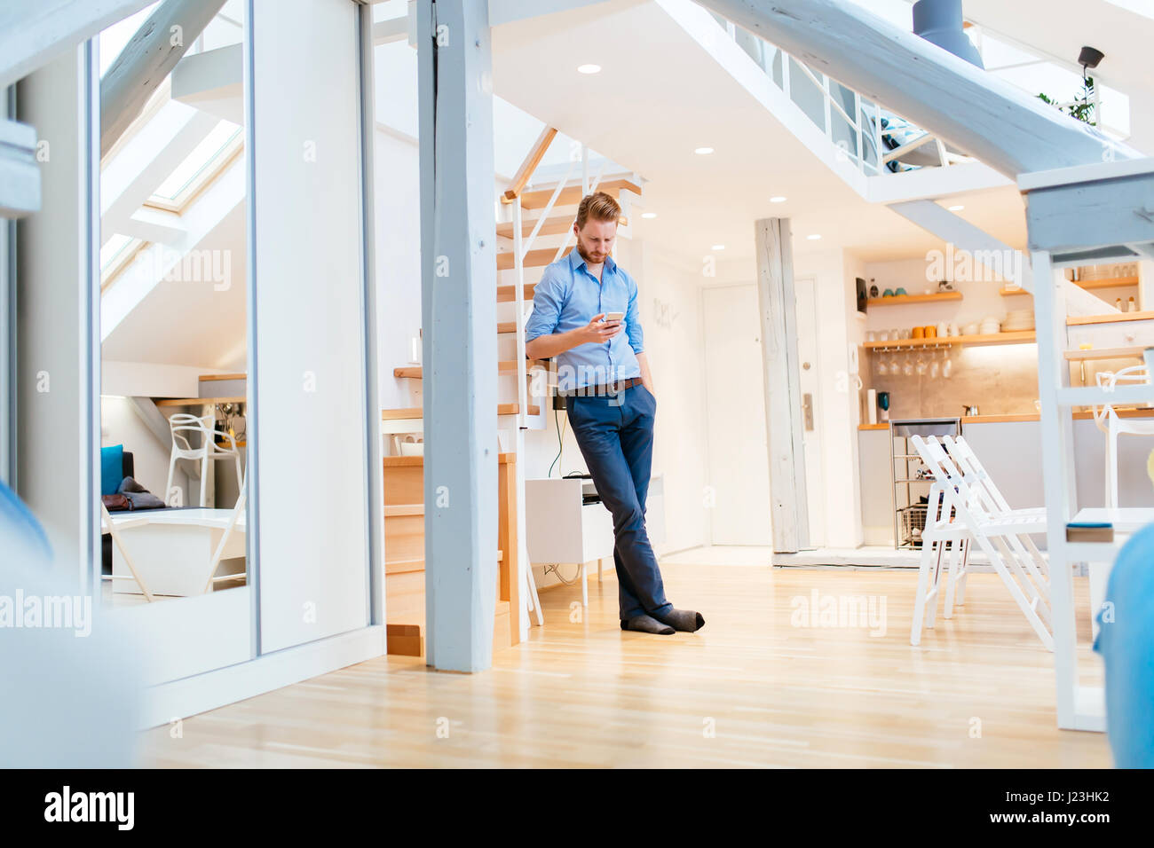 Handsome business at home holding phone and calling colleague after ...