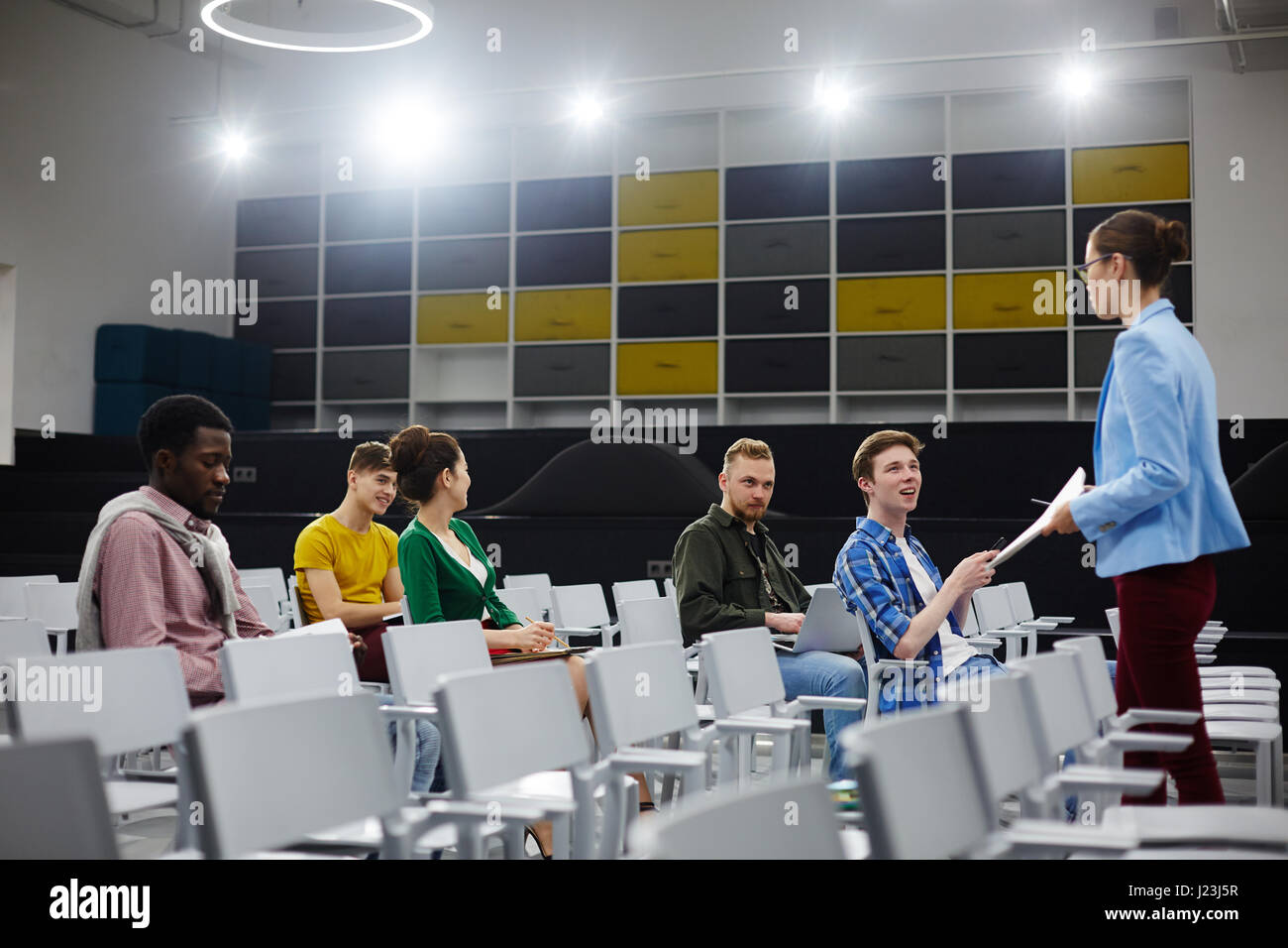 Several students discussing topic of presentation with teacher Stock ...
