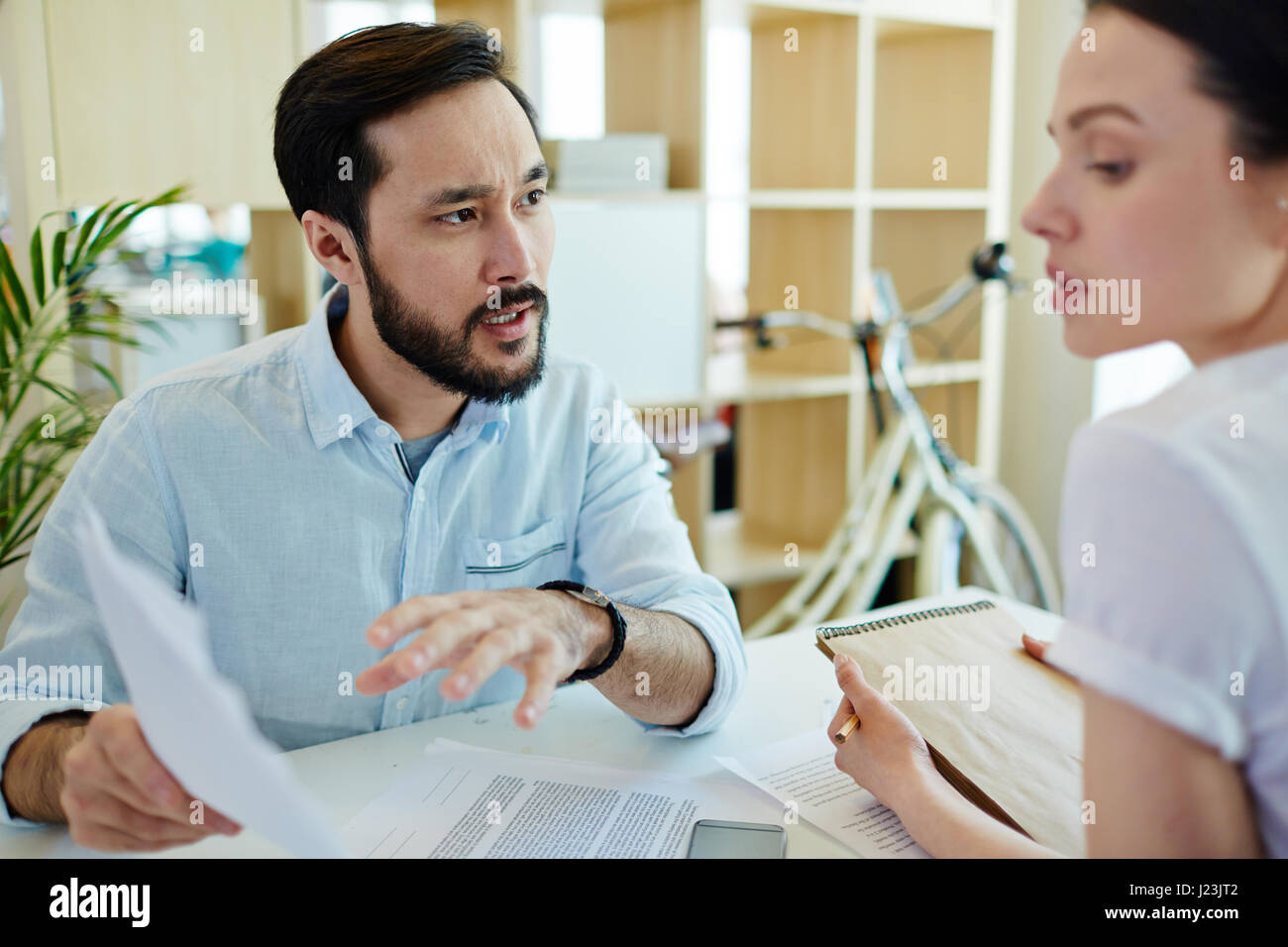 Portrait of two tense business people having discussion of work during ...