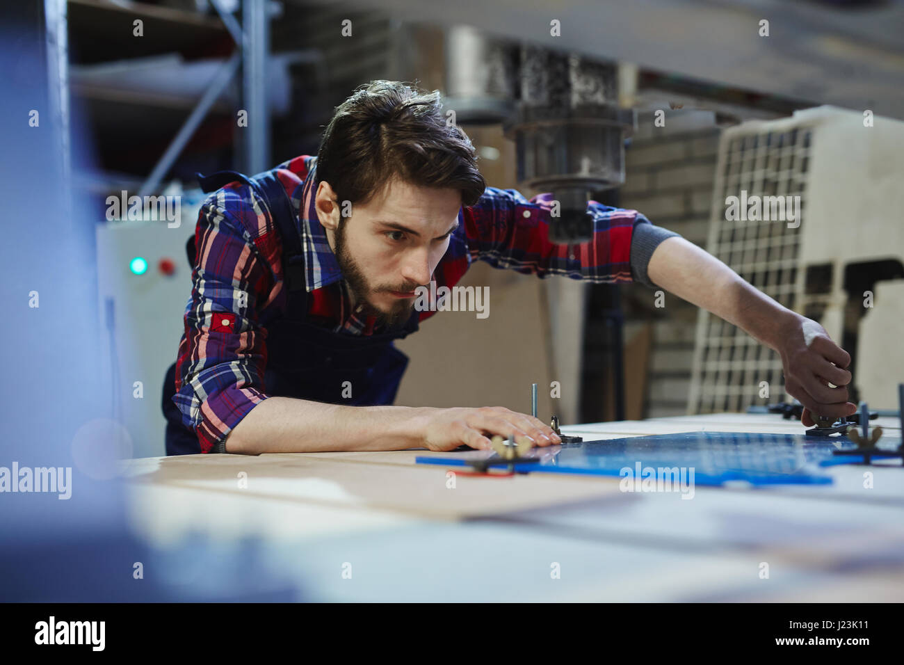 Professional technician doing his work in workshop Stock Photo - Alamy