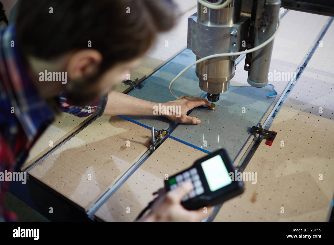 Mechanic fixing glass detail under lathe machine Stock Photo - Alamy