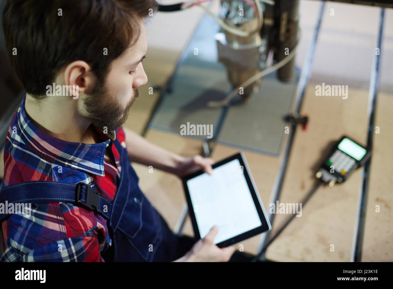 Young technician with touchpad at work Stock Photo - Alamy