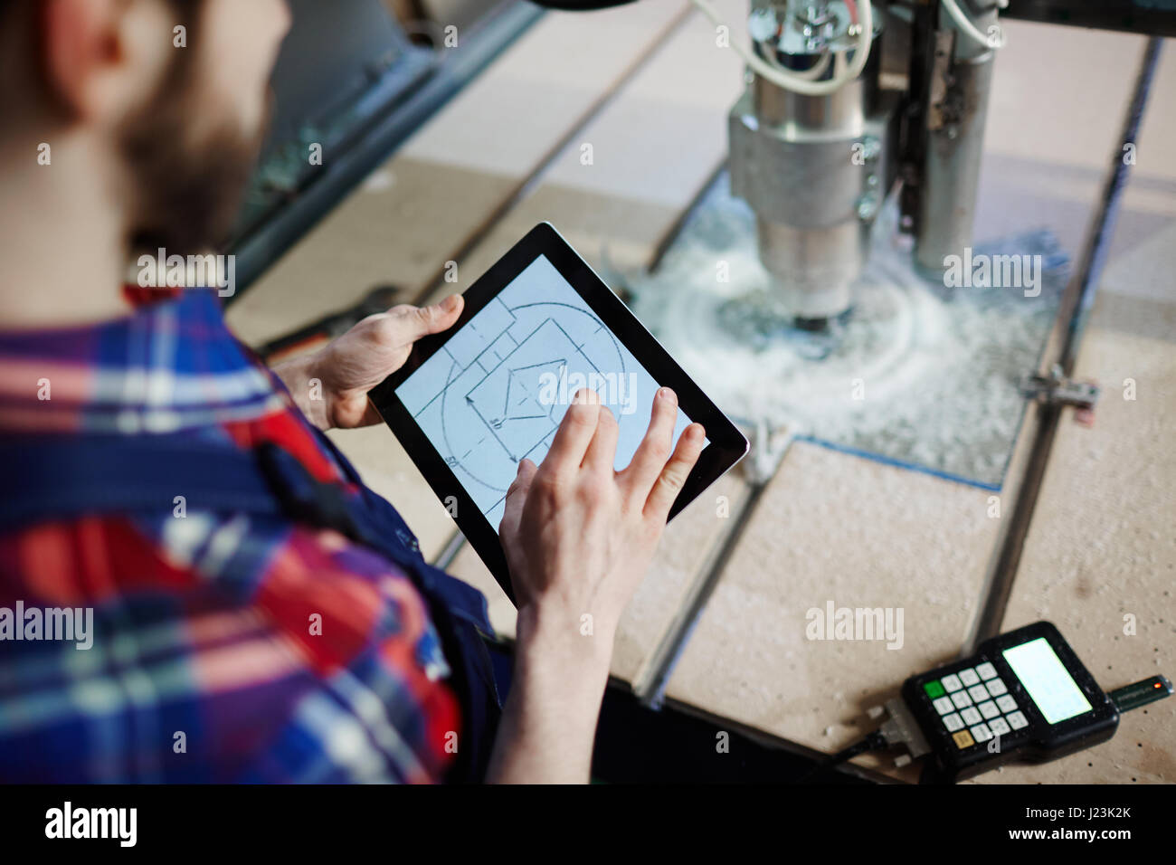 Technical sketch in touchpad held by mechanic Stock Photo - Alamy