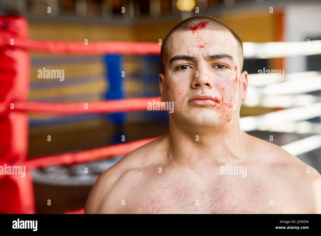 Portrait of strong muscular man looking at camera with determination ...