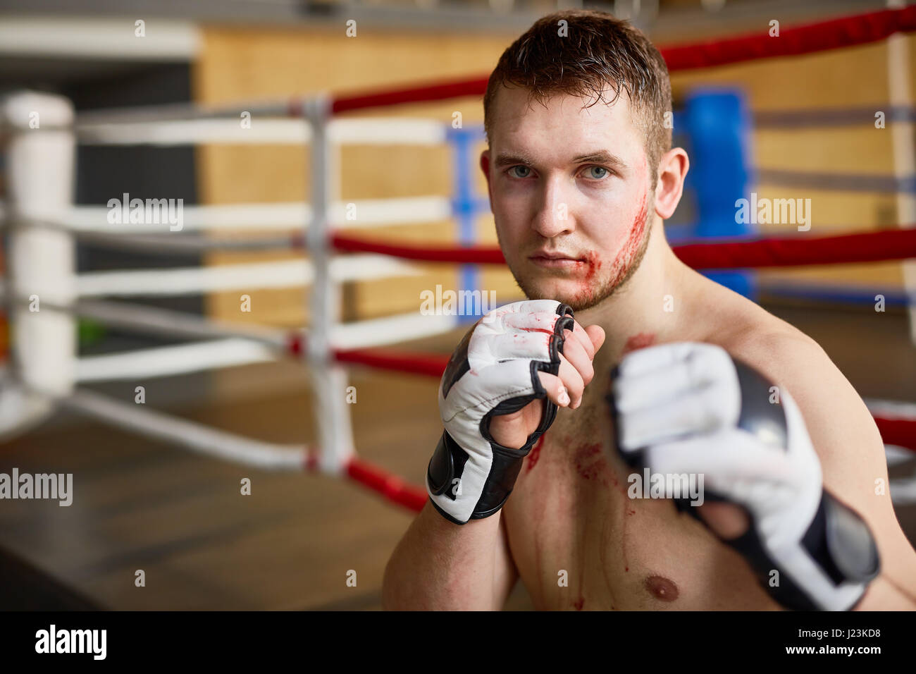 Portrait of strong muscular man looking at camera with determination ...