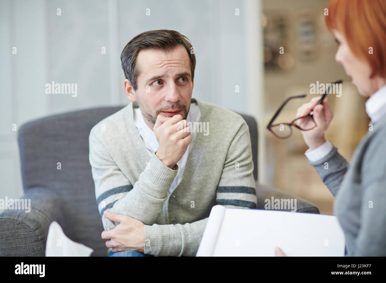 Worried man telling about his fears to psychiatrist Stock Photo - Alamy