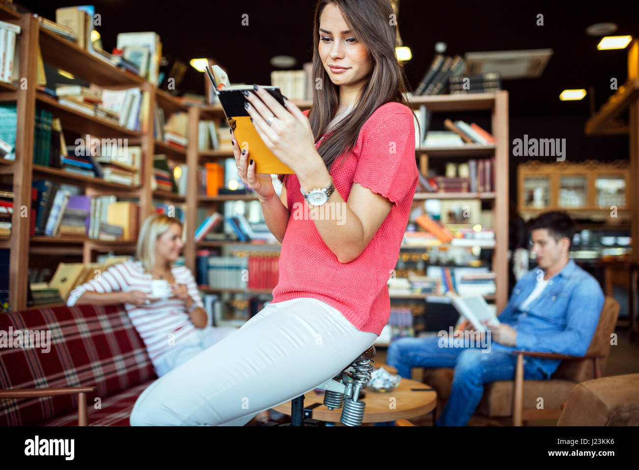 Intellectual students reading books in library Stock Photo - Alamy