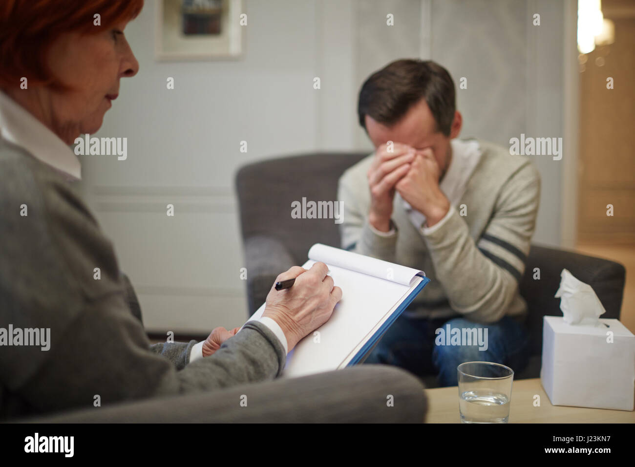 Psychiatrist writing down story of her patient Stock Photo - Alamy