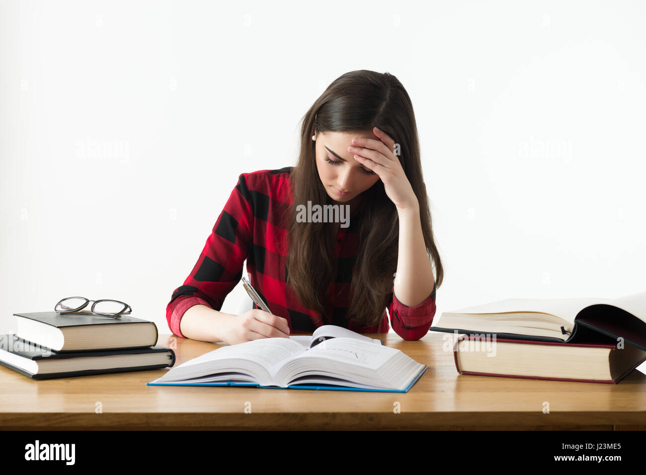 Attractive caucasian girl studying for her exams at home, education ...