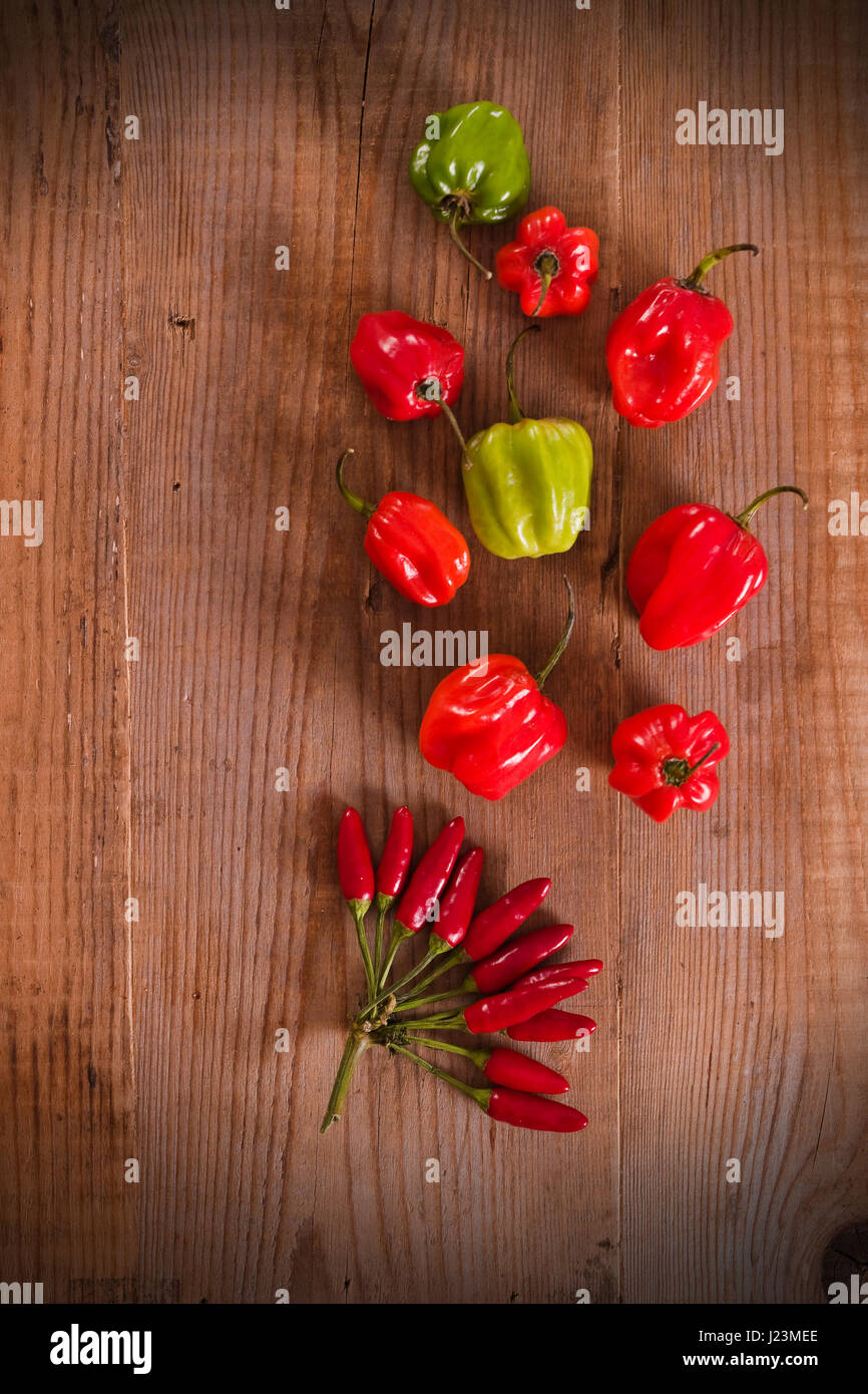 Red hot chili peppers on wooden table Stock Photo - Alamy