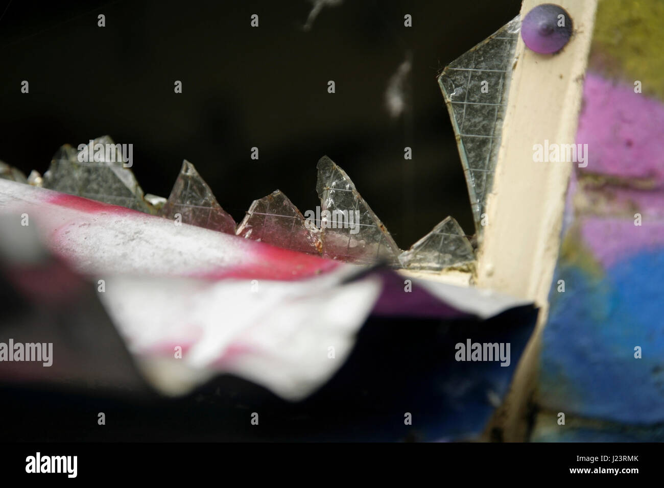 Broken wire reinforced window in abandoned derelict industrial building ...