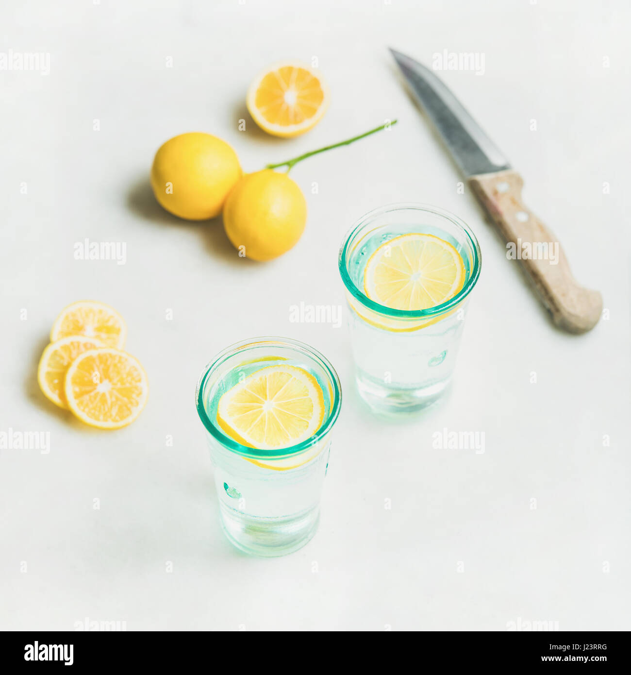 Morning detox lemon water in glasses over grey marble background Stock ...