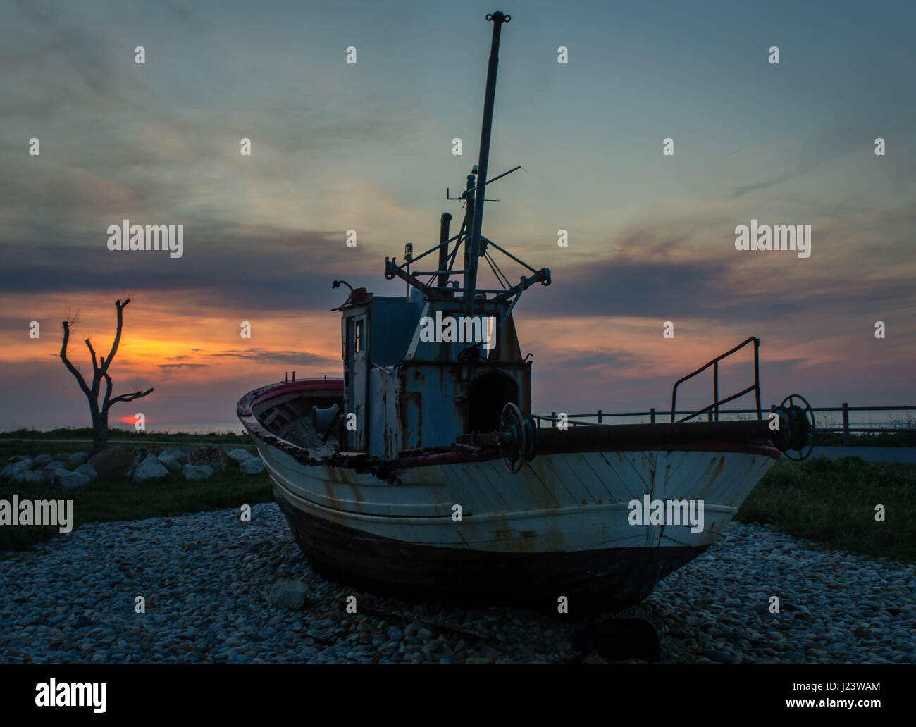 Tugboat at Sunset, Baiona, Galicia, Spain. A shipwrecked rusty tugboat ...