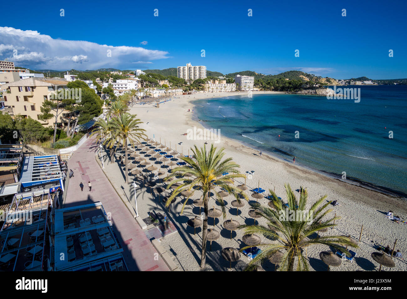 Part of the bay of Peguera with hotels, beach and some sun shades Stock ...