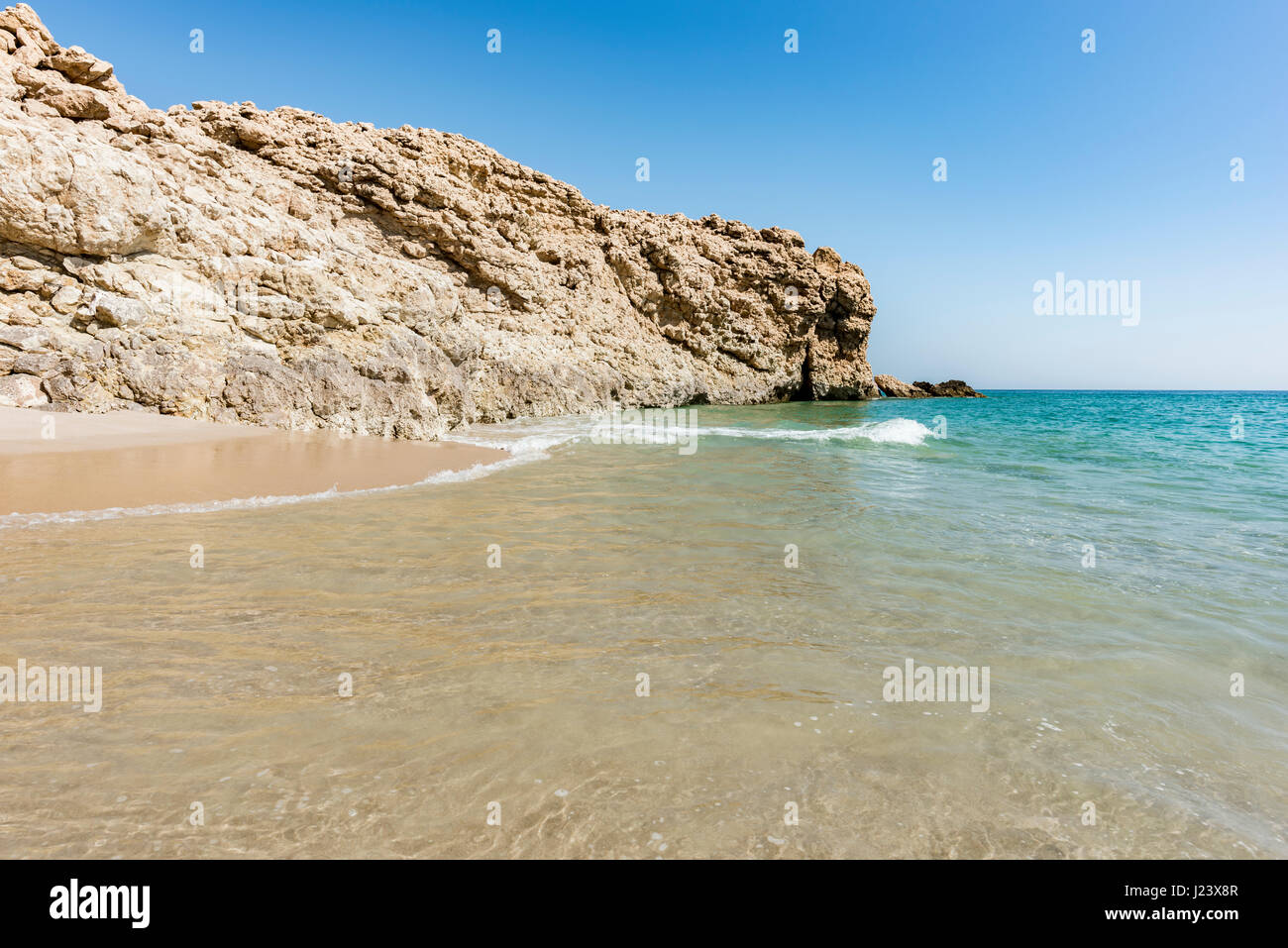 Scenic view of a cliff and rugged beach at Ras Al Jinz, Oman, gentle ...