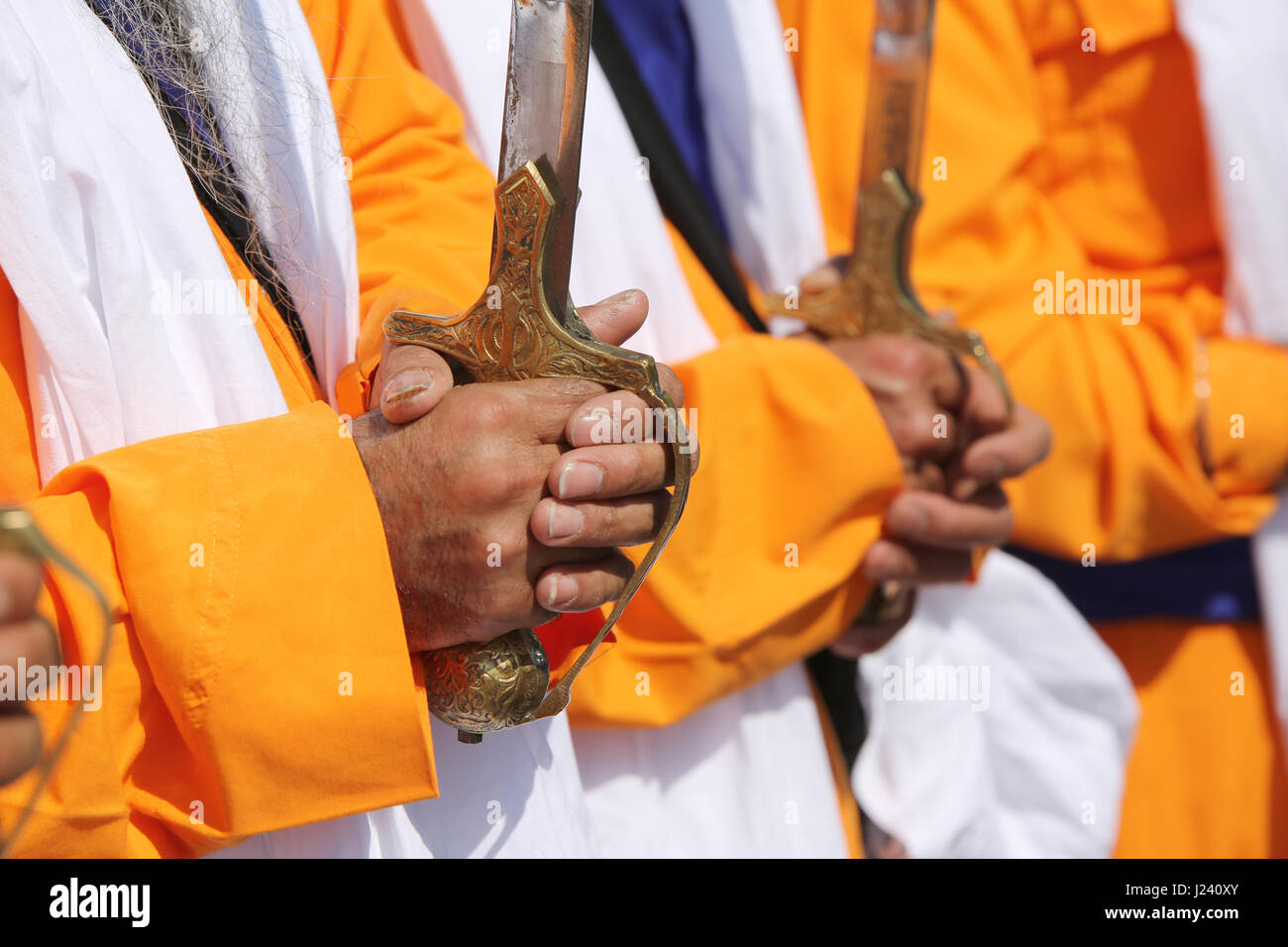 Detail of religious men Sikh during religious ceremony with sword in ...