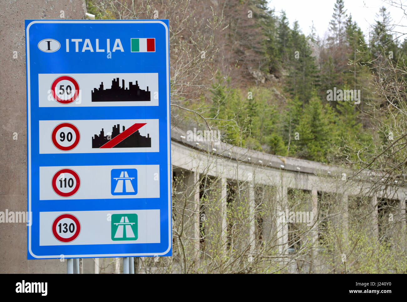 Road sign at the Italian border with indications of the speed limits to ...