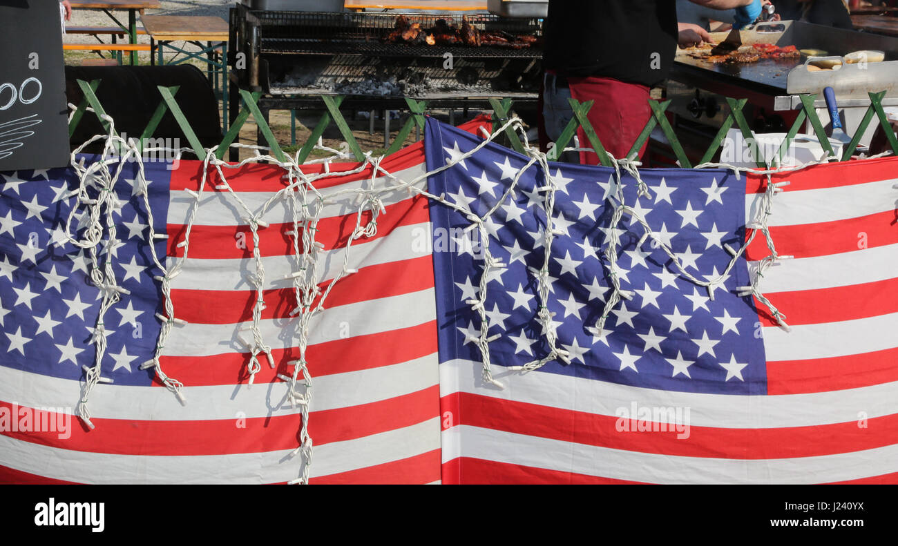 two large American flags in the street food stall while the cook ...