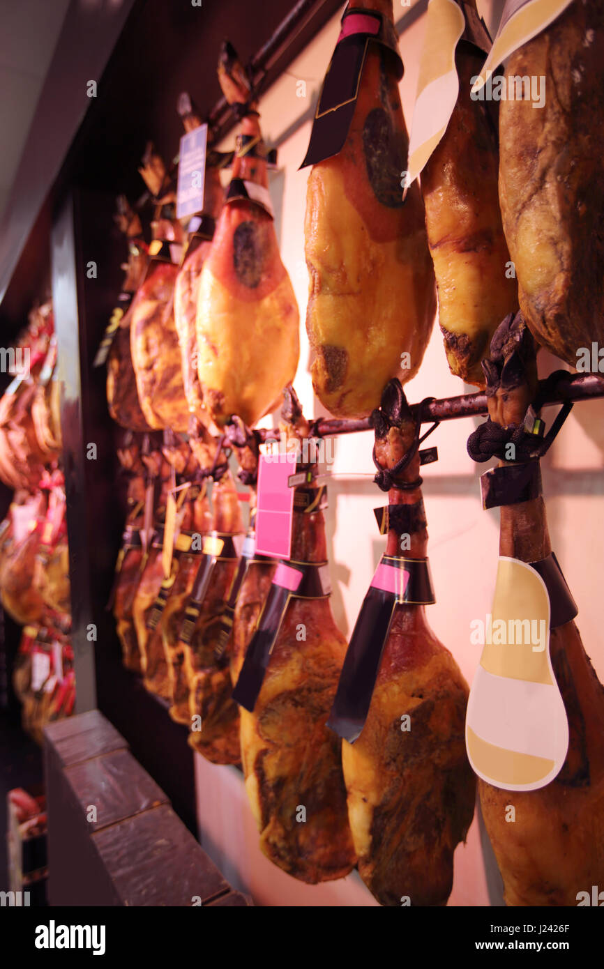 Traditional spanish jamon legs on showcase in store Stock Photo - Alamy