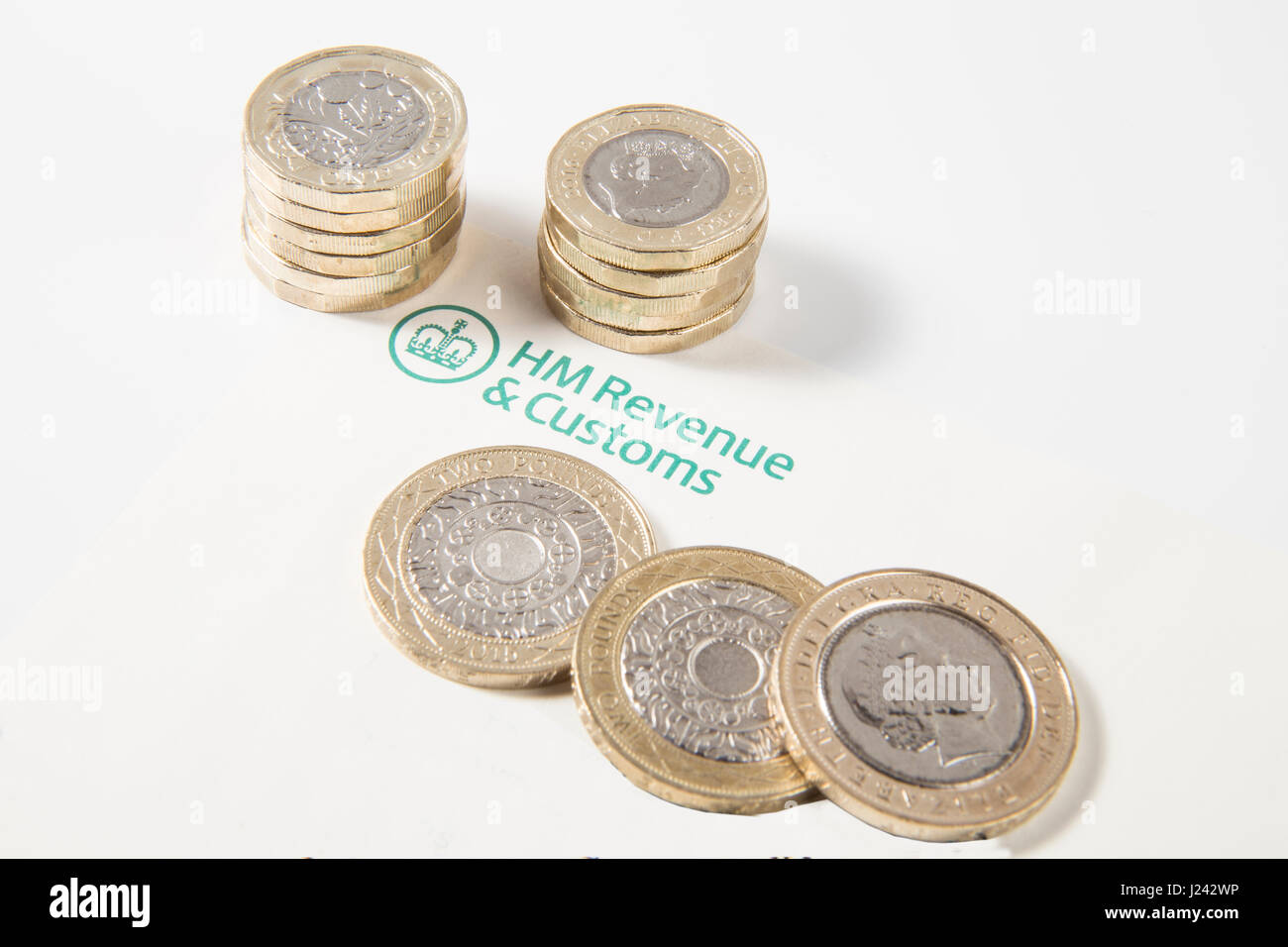 New £1 coins and £2 pound coins on a HM Revenue & Customs letter Stock ...