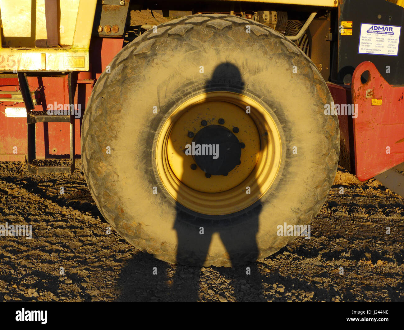 Huge tire on duty earth moving equipment Stock Photo - Alamy