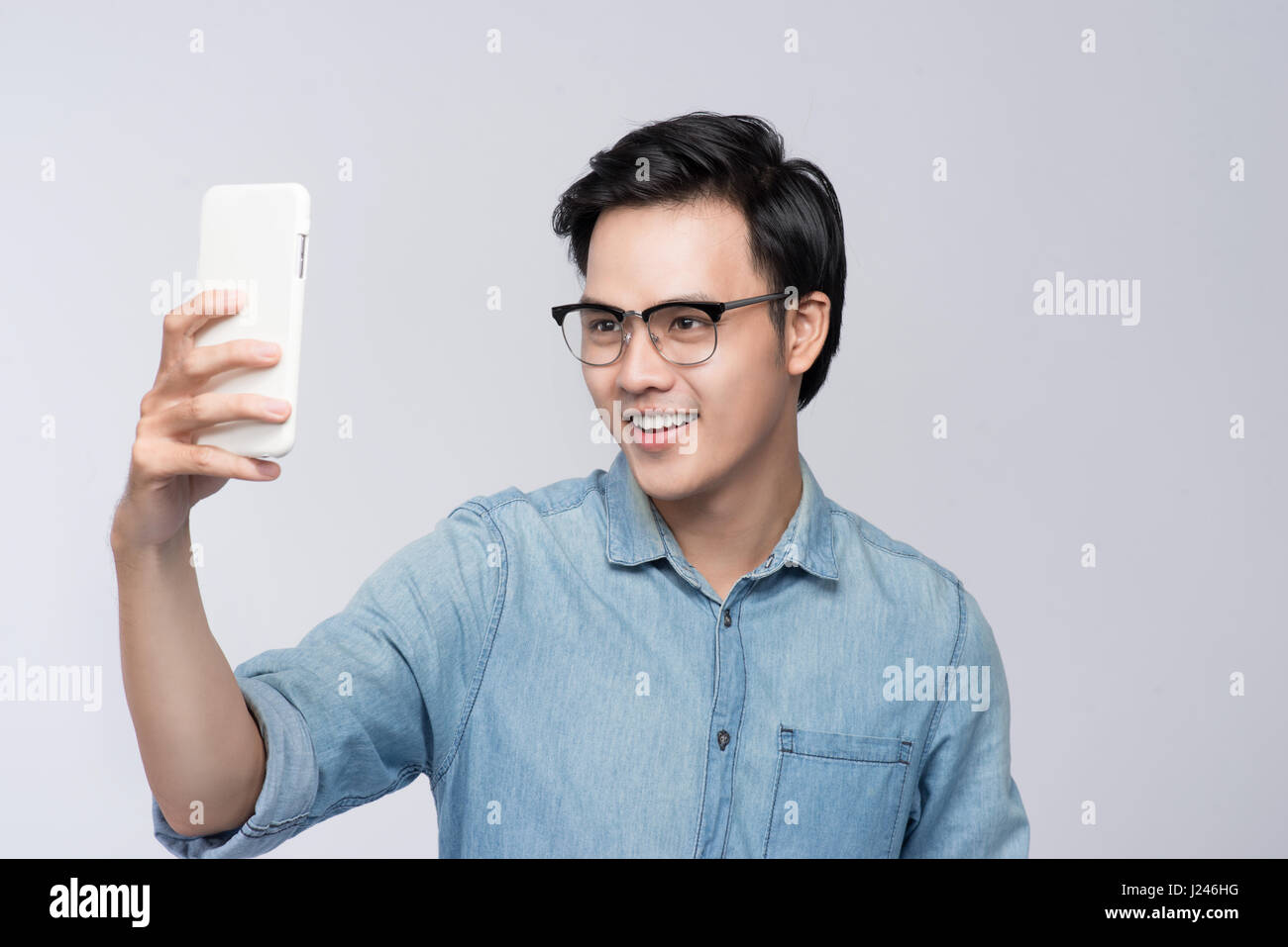 Smart casual asian man taking selfie photo by smartphone Stock Photo ...