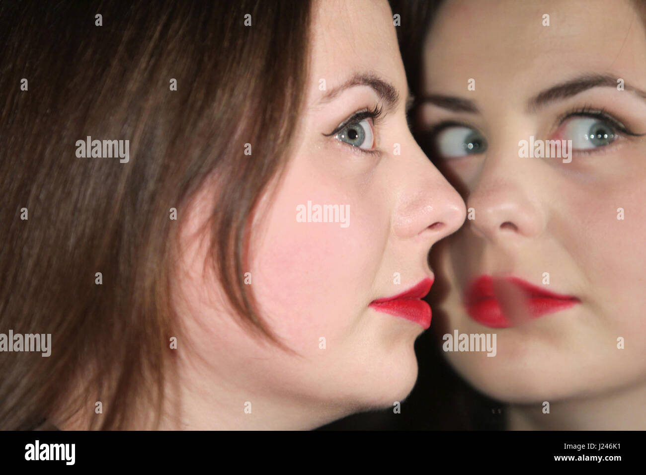 Portrait of a young brunette with scared face expression posing in ...