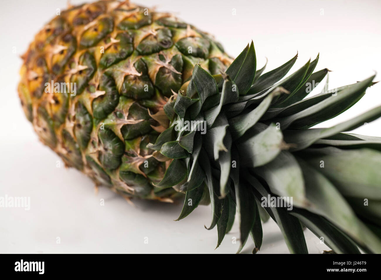 Pineapple on the table. Horizontal position of fruit Stock Photo - Alamy
