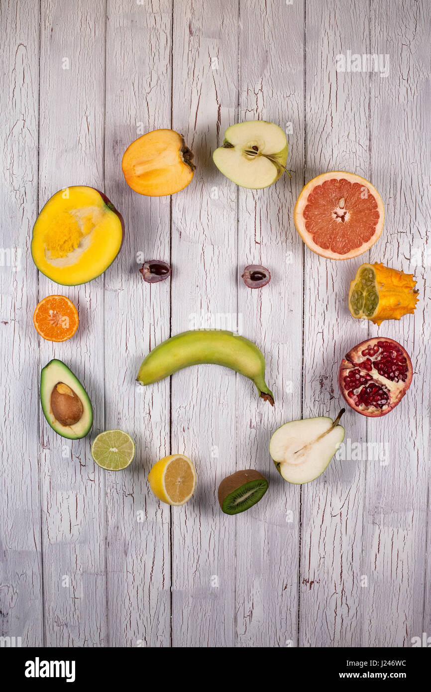 Vertical shot of cut into two fruits in a form of a face Stock Photo ...