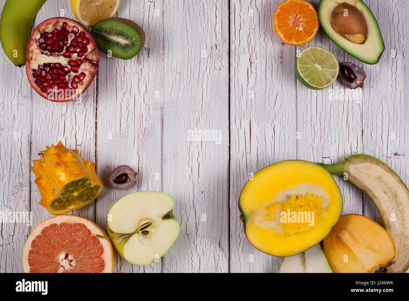 Nice composition of tropical fruits. Fruits situated on a white wooden ...